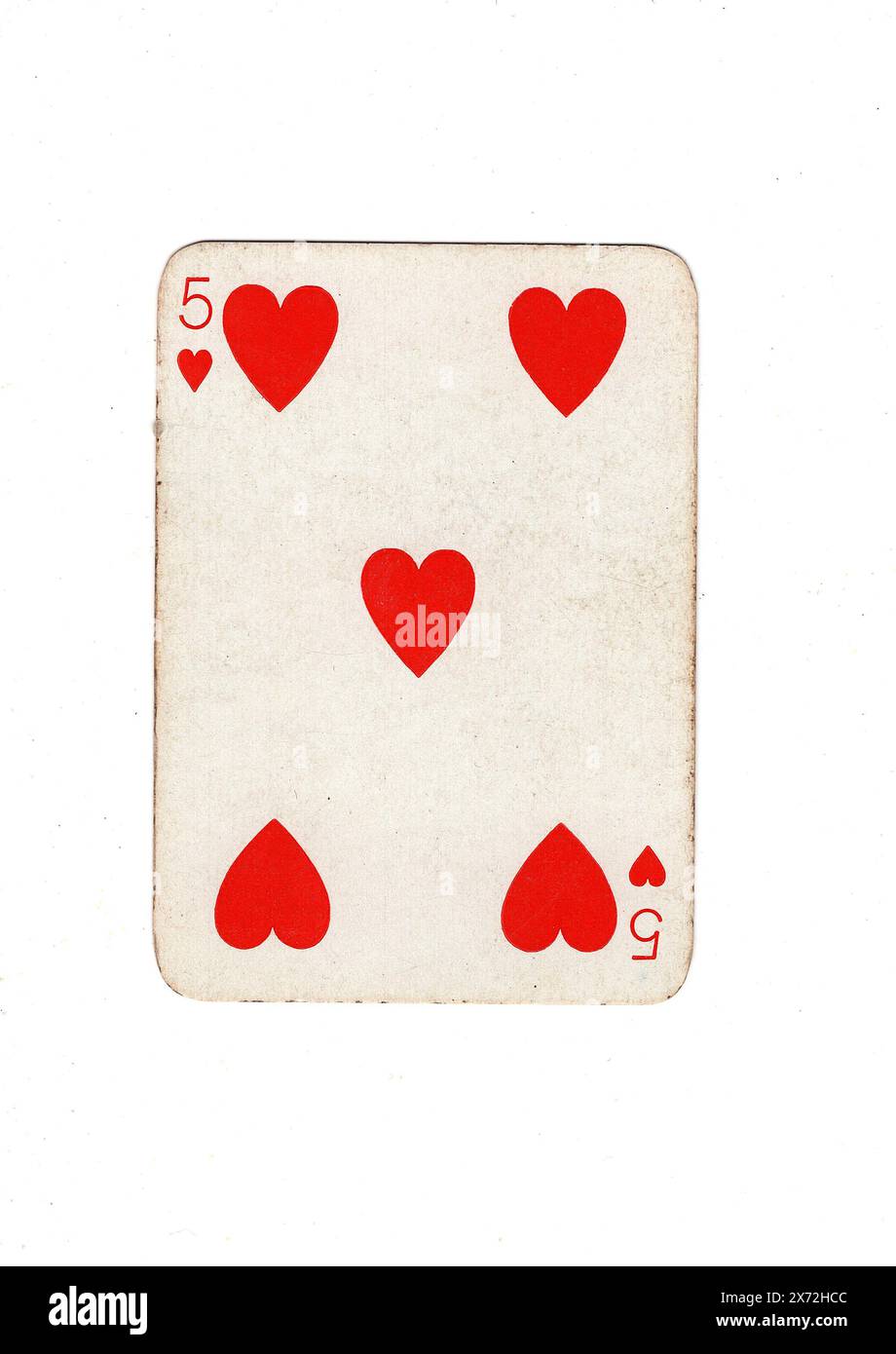 An antique five of hearts playing card isolated on a white background ...