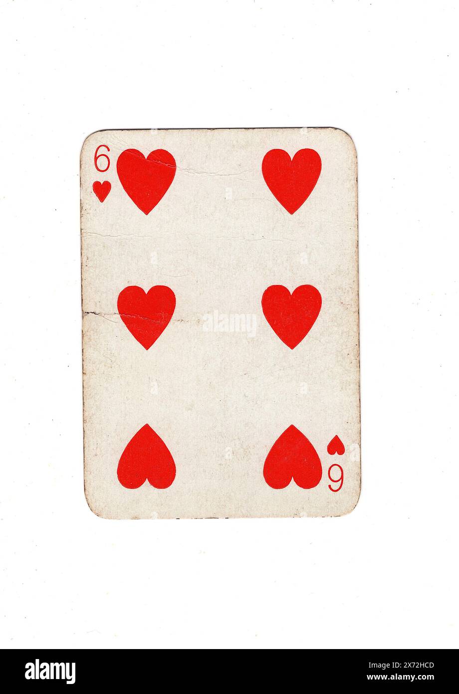 An antique six of hearts playing card isolated on a white background ...