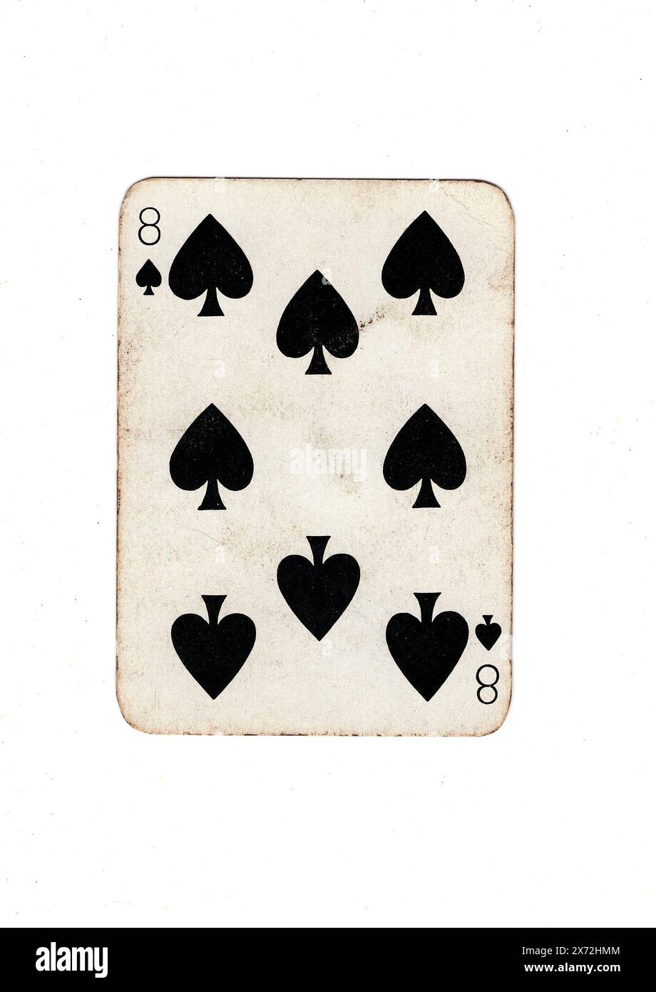 An antique eight of spades playing card isolated on a white background ...