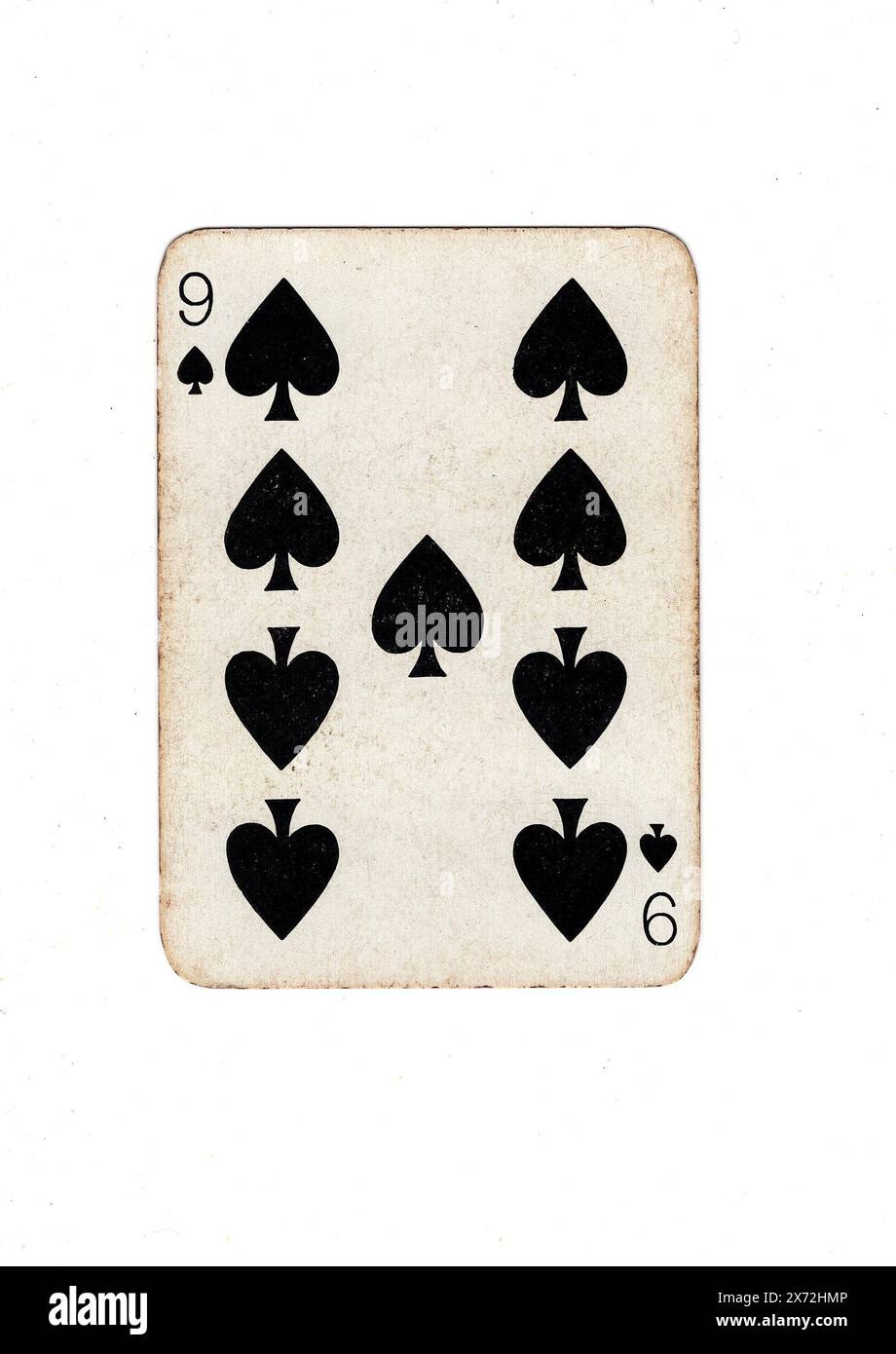 An antique nine of spades playing card isolated on a white background ...