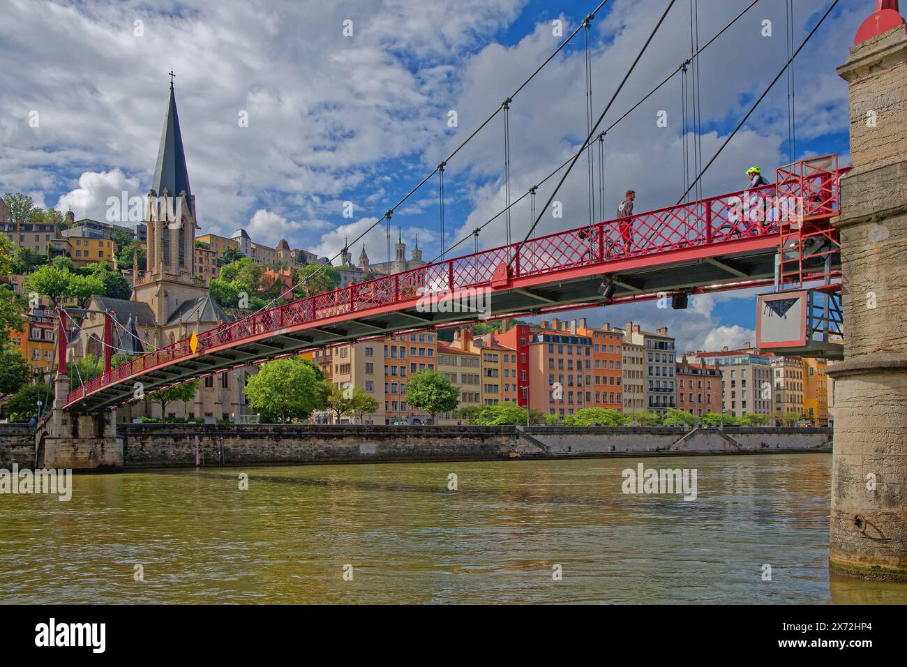 LYON, FRANCE, May 15, 2024 : Bikers on the pedestrian bridge over Saone ...