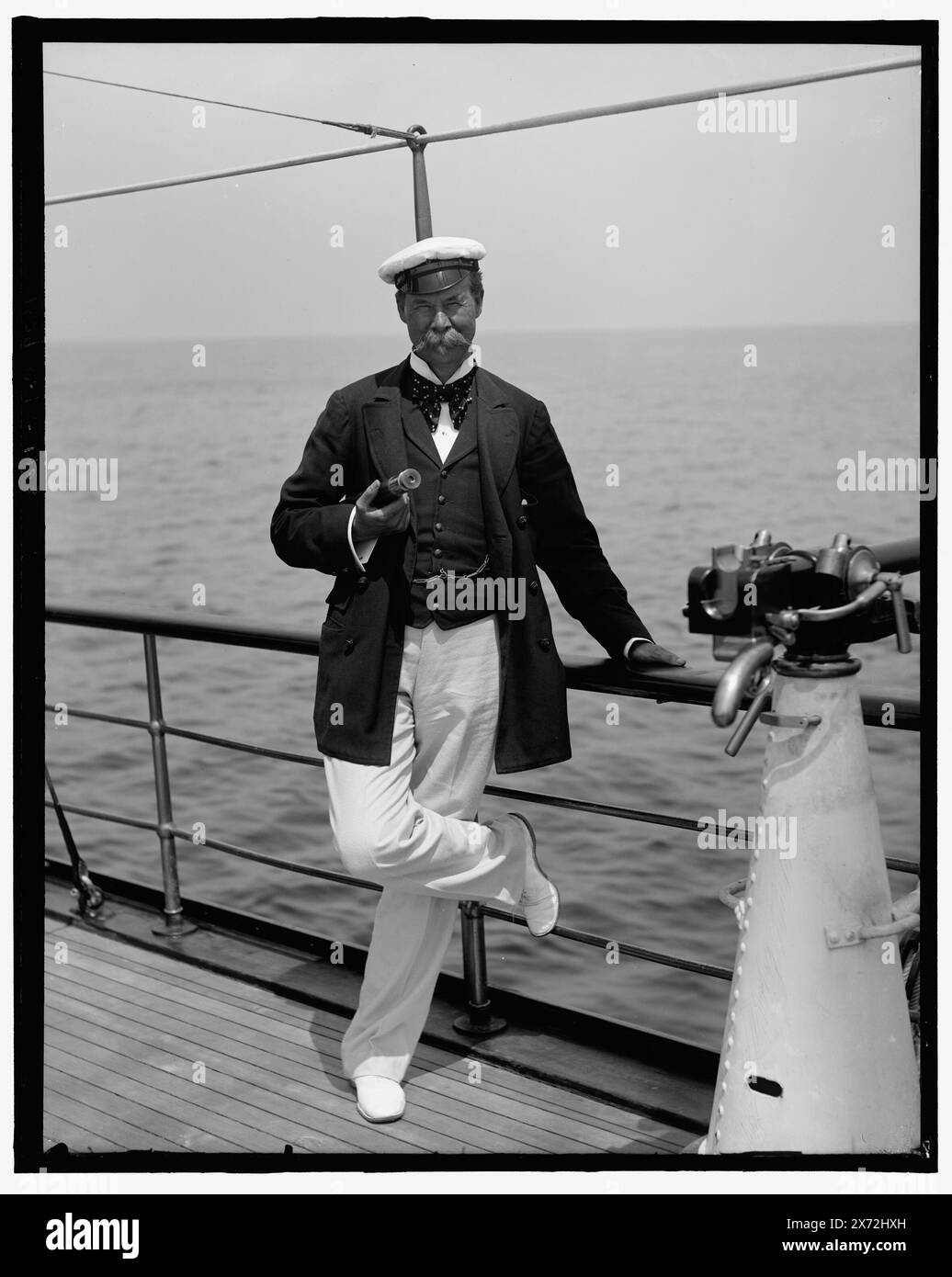 Man posed with nautical equipment on ship deck, Title devised by ...