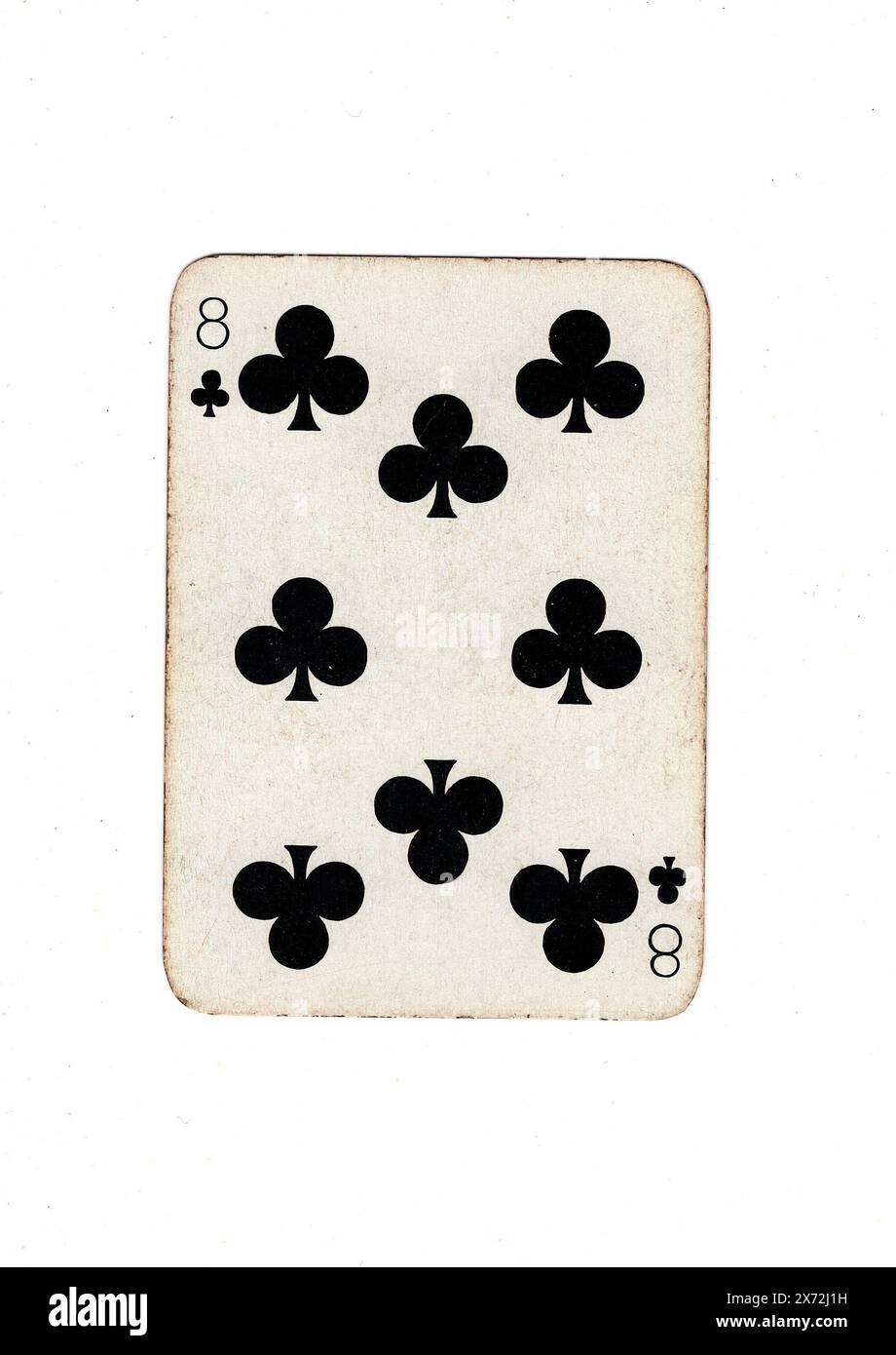 An antique eight of clubs playing card isolated on a white background ...