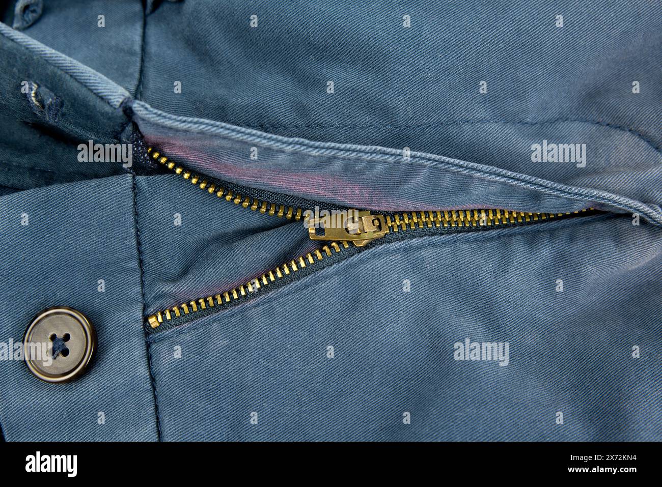 Old pants zip with a fade out fabric color Stock Photo - Alamy