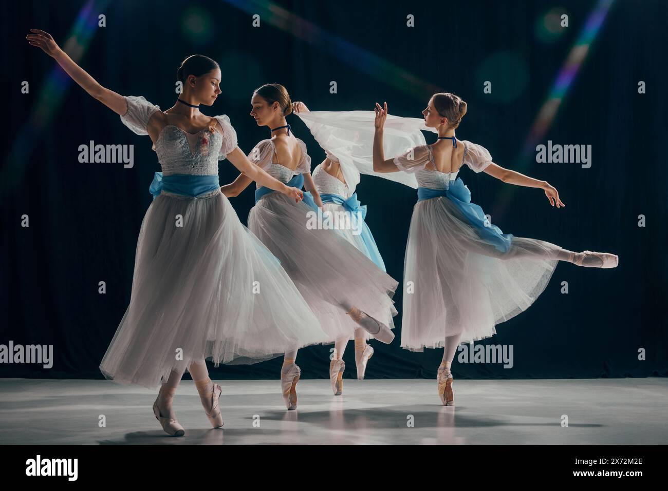 beauty of ballet. Dynamic portrait of four ballet dancers in white and ...