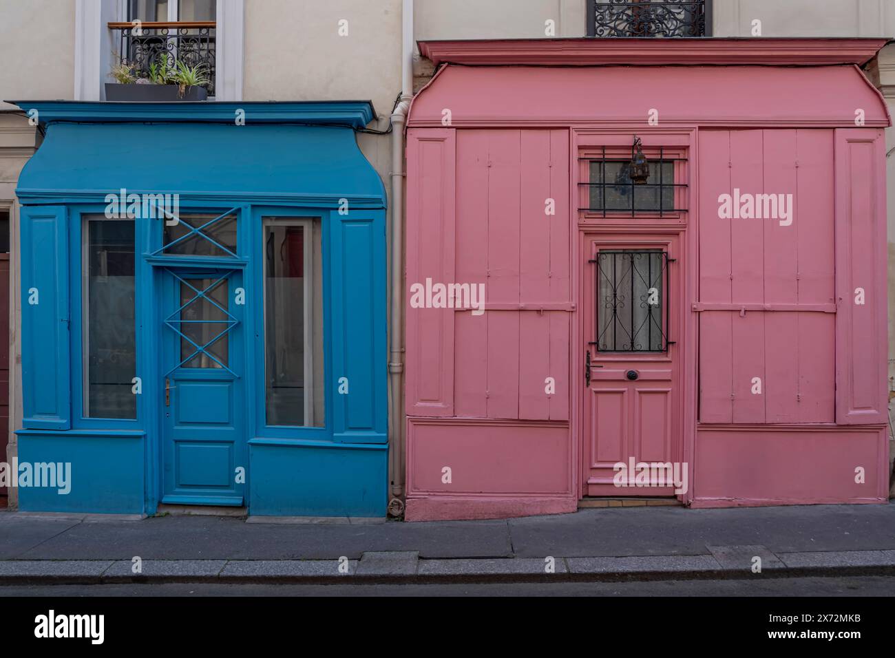 Paris, France - 05 11 2024: View of typical blue and pink windows shop ...