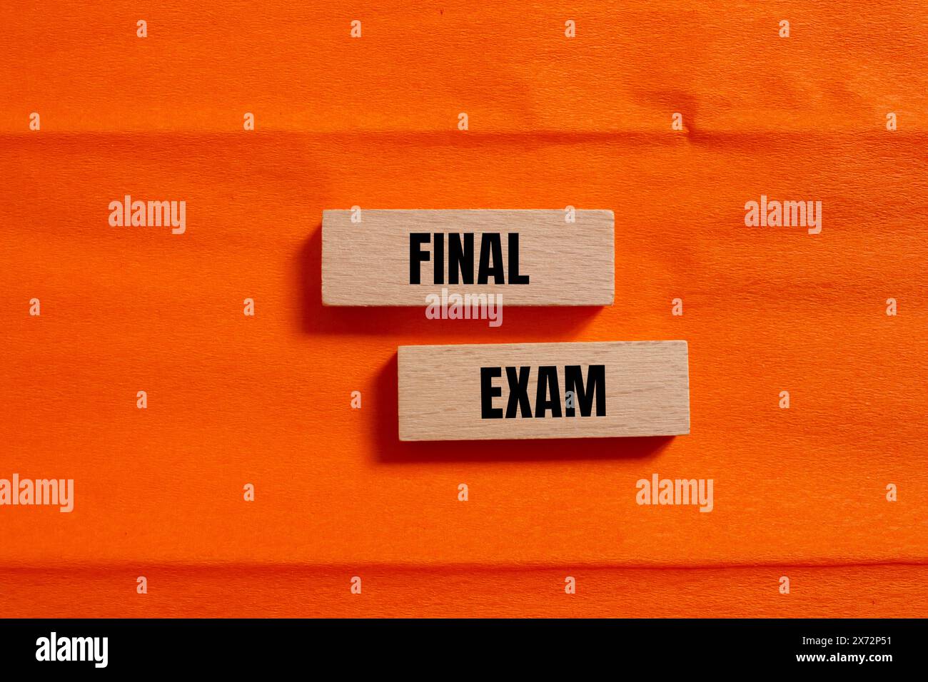 Final exam words written on wooden blocks with orange background ...