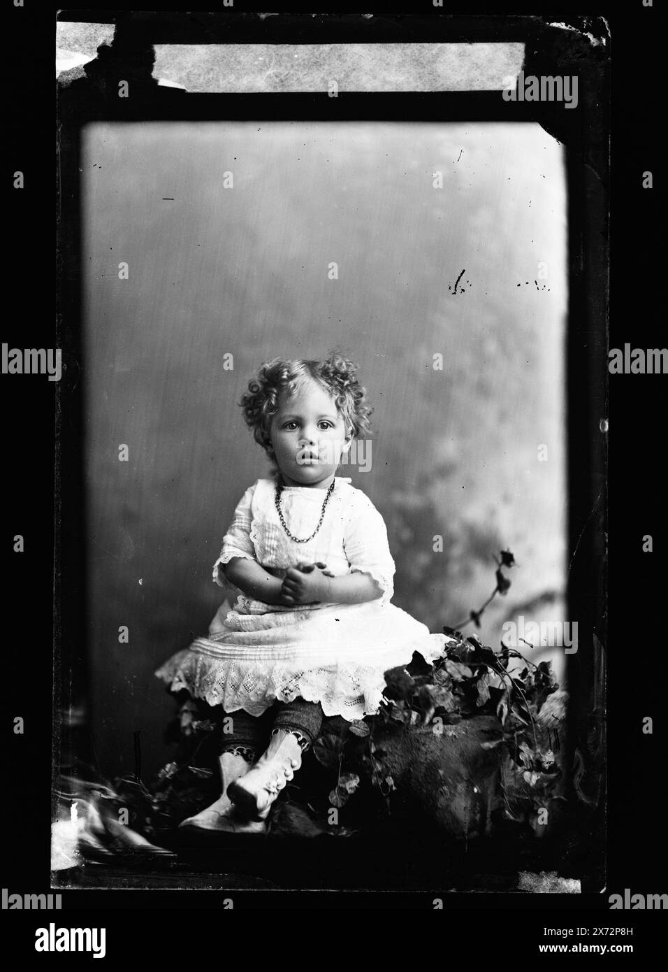 Louise Jackson, seated on rock in a studio, full-length portrait, Title ...