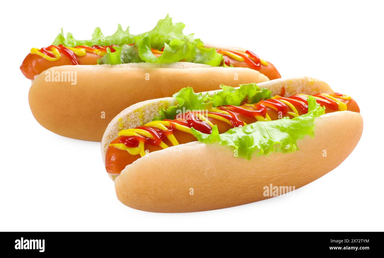 Tasty hot dogs with lettuce, ketchup and mustard isolated on white ...