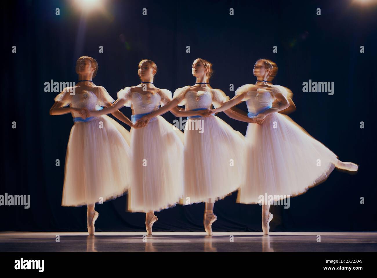 Charming young girls, ballet dancers in white tutus with blue bows on ...