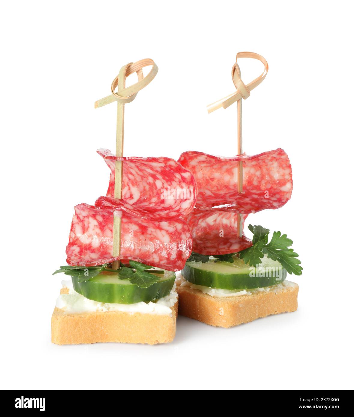 Tasty canapes with salami, cucumber and cream cheese isolated on white ...