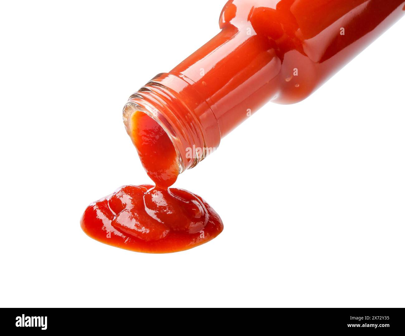 Pouring tasty ketchup from bottle isolated on white. Tomato sauce Stock ...