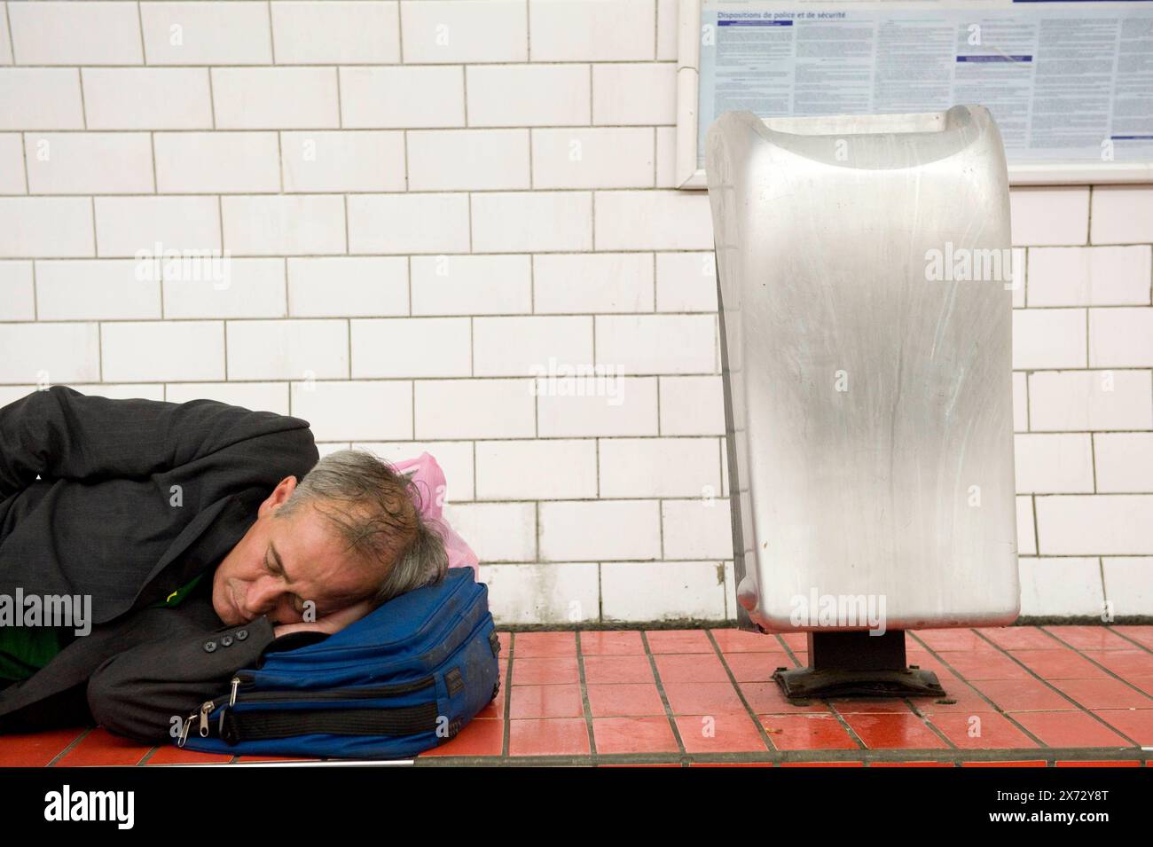 Homeless Man Sleeping Homeless Man Sleeping near a Public Trash ...