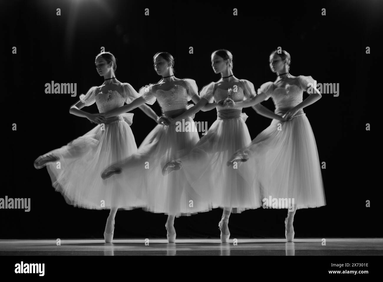Young girls, ballerinas in white tutus with blue bows dancing in motion ...