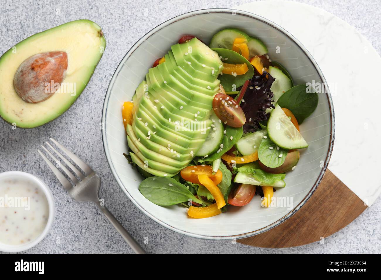 Healthy dish high in vegetable fats on light textured table, flat lay ...