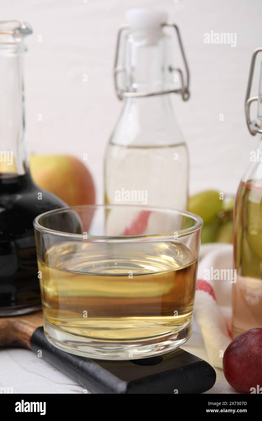 Different types of vinegar on white table Stock Photo - Alamy