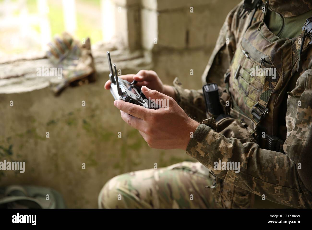 Military mission. Soldier in uniform with drone controller inside ...