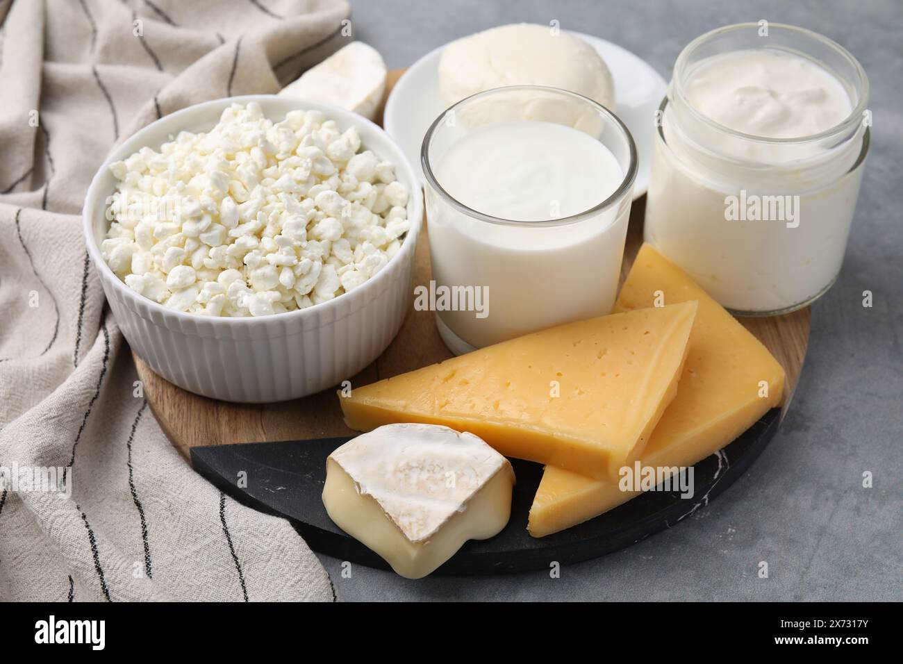 Different fresh dairy products on grey table Stock Photo - Alamy