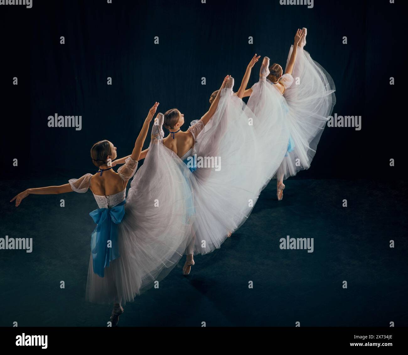 Harmony and beauty. Four ballerinas perform synchronized dance, their ...