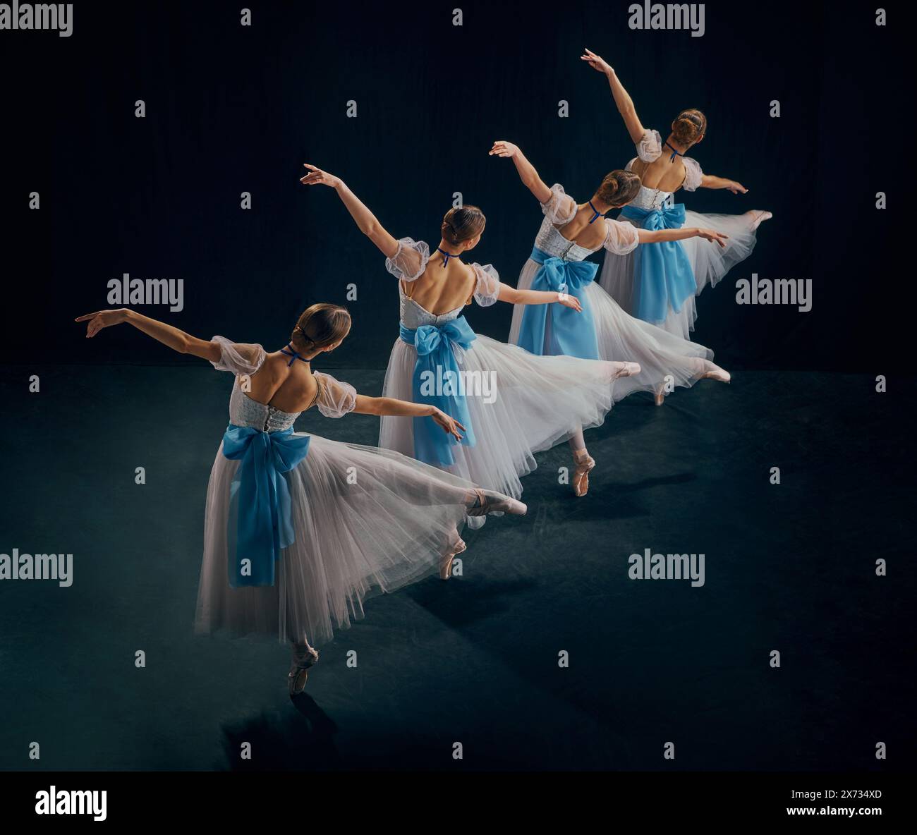 Four ballerinas in beautifully choreographed pose, their white tutus ...