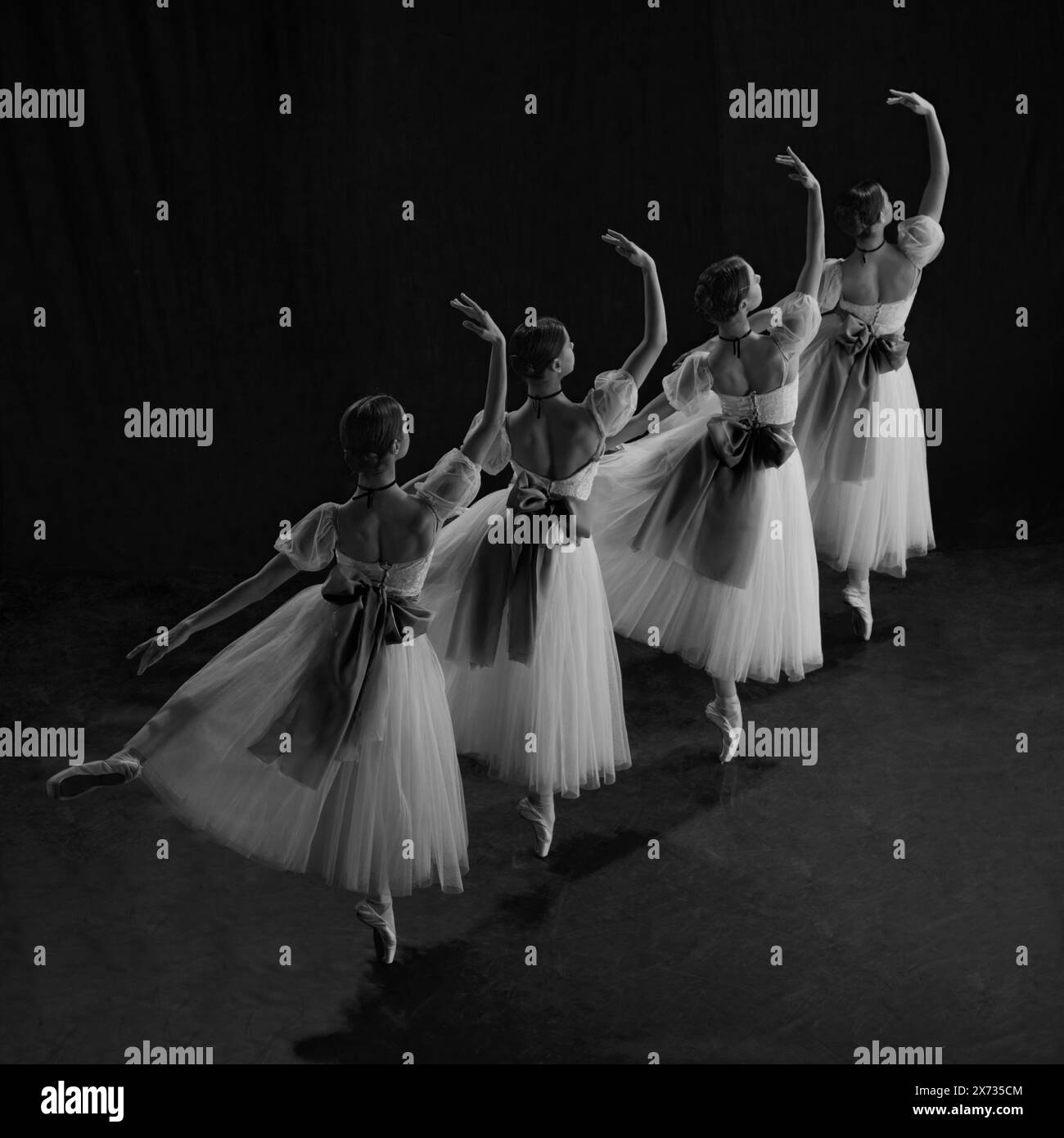 Ballerinas elegantly performing on stage, dresses flowing gracefully as ...
