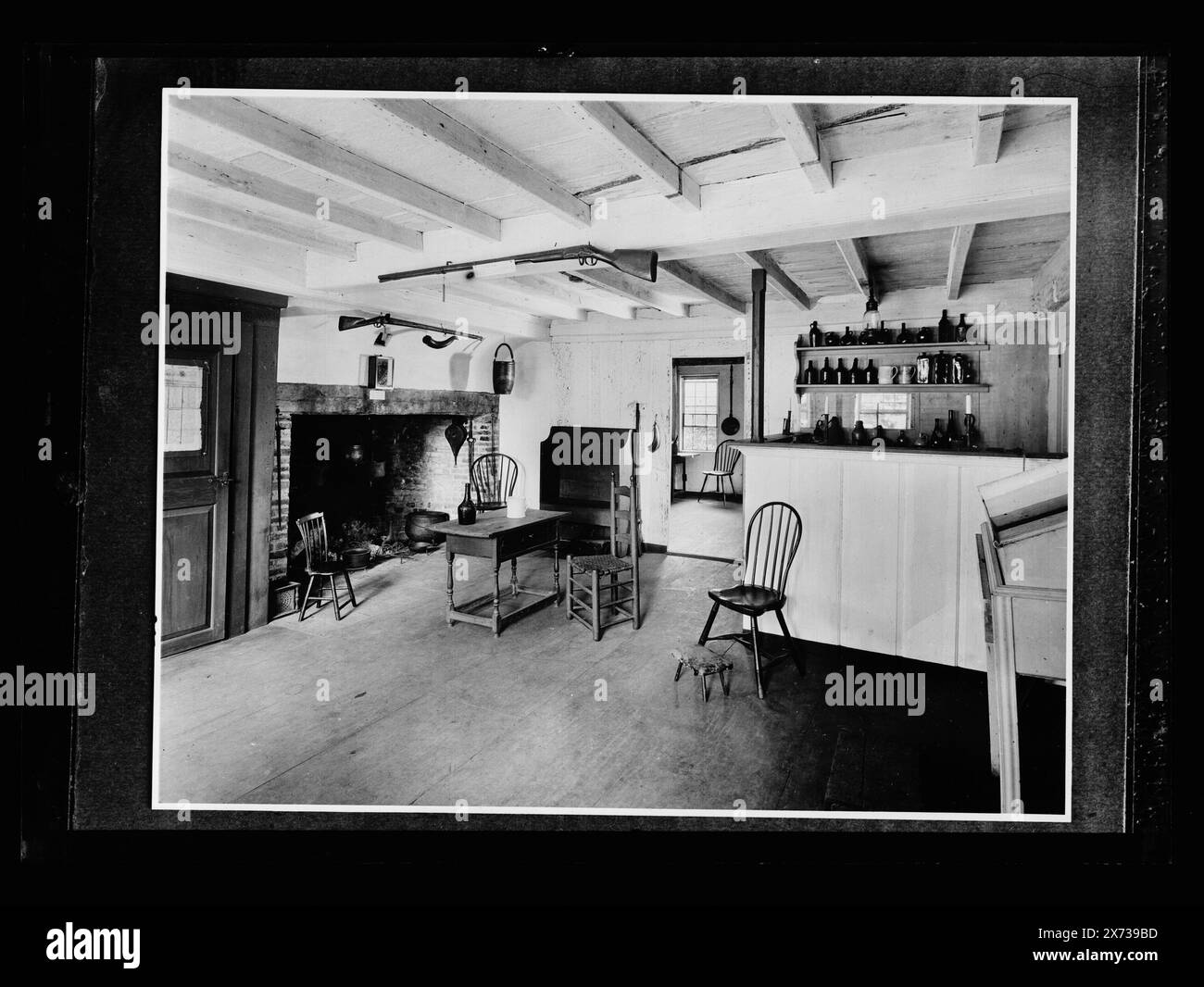 Interior, colonial-style kitchen with firearms, Title devised by ...