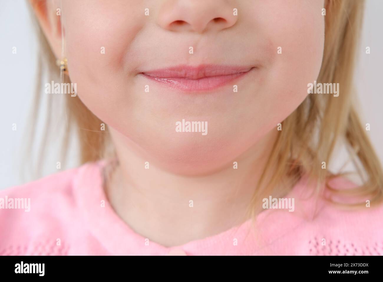 close up lower part child face, blonde girl 3 years old cheerful smile ...