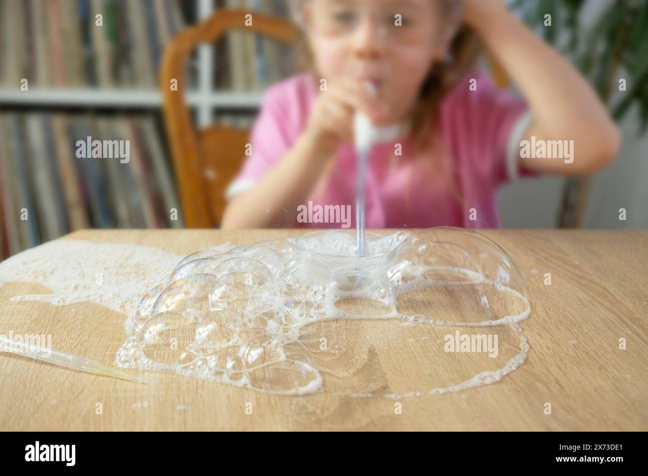 Little girl blows bubbles made of soap foam, bursts, kids fun games ...
