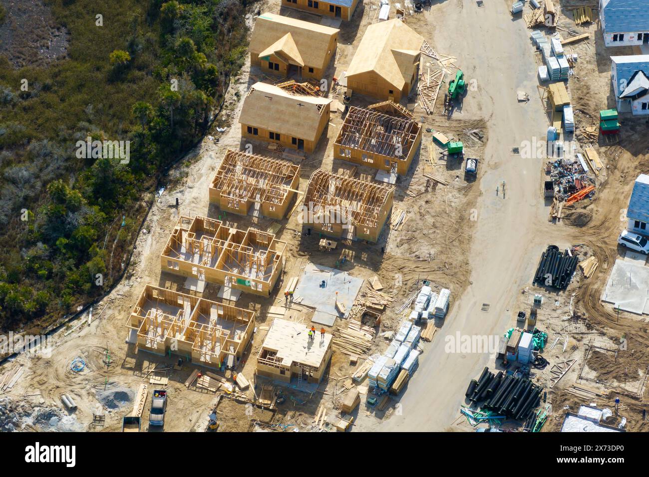 Wooden houses under construction in new developing suburban area ...