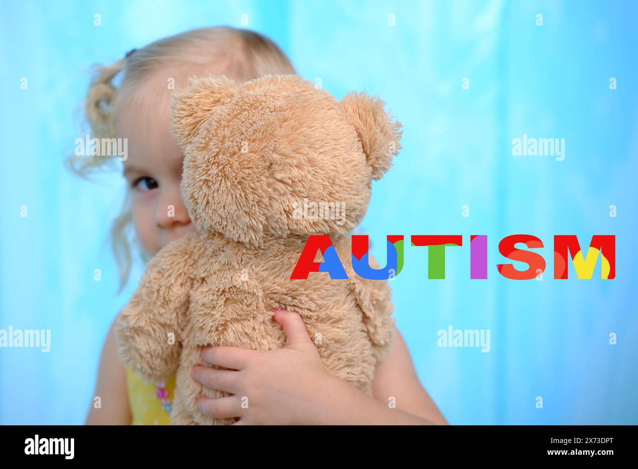 little child with autism, blonde girl 3 years old plays with toy, hugs ...