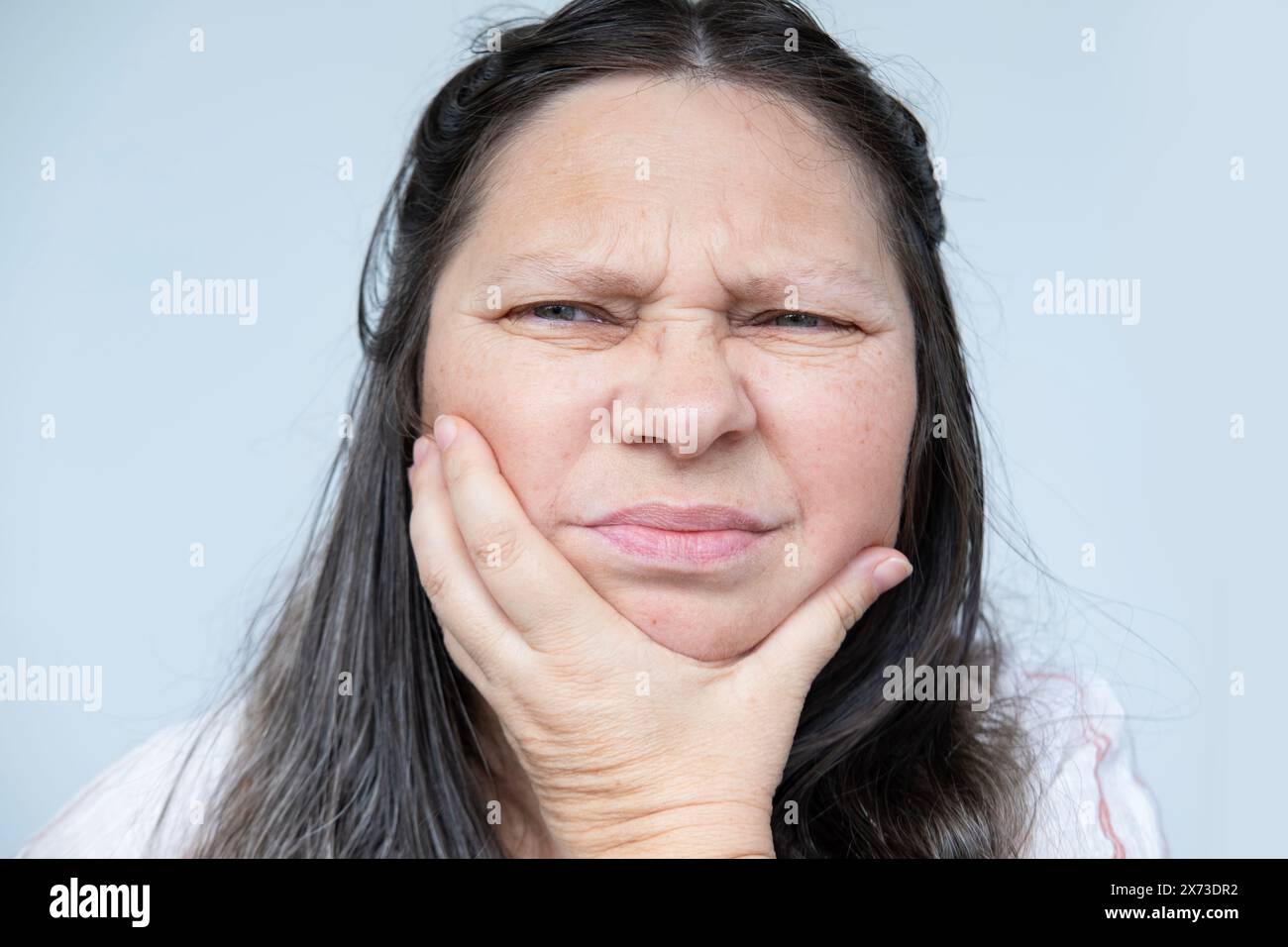 caucasian mature woman face with gumboil, toothache, gum inflammation ...