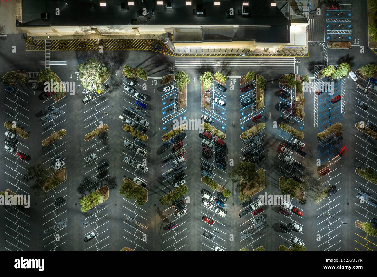 Aerial view of many cars parked on parking lot with lines and markings ...