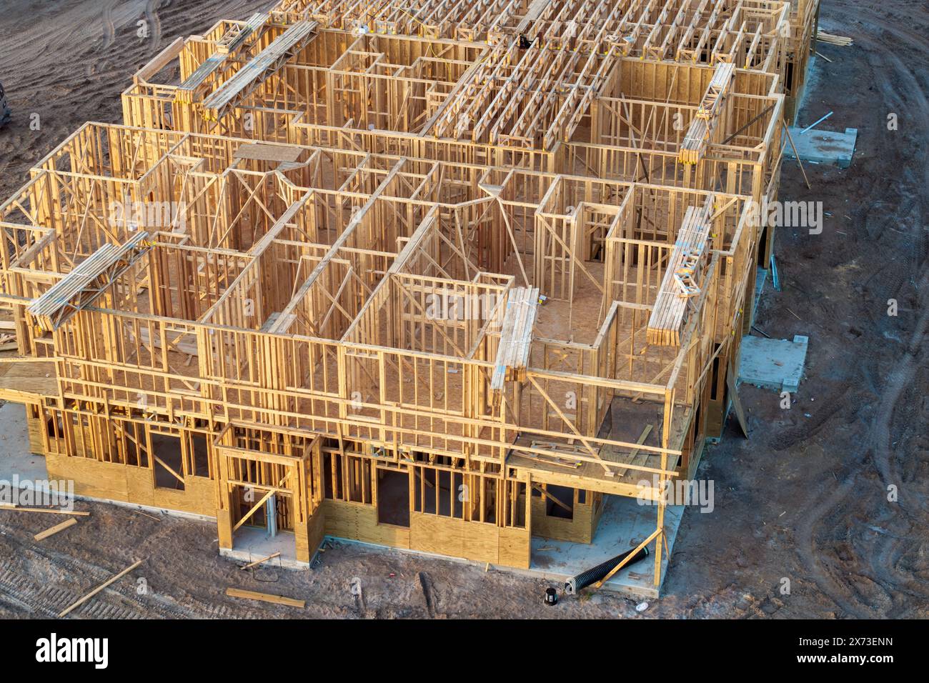Aerial view of unfinished wooden frames of apartment buildings under ...