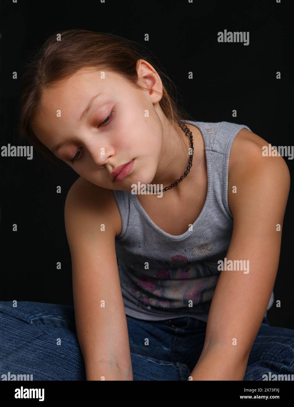 portrait of a sad preteen girl on black background Stock Photo - Alamy