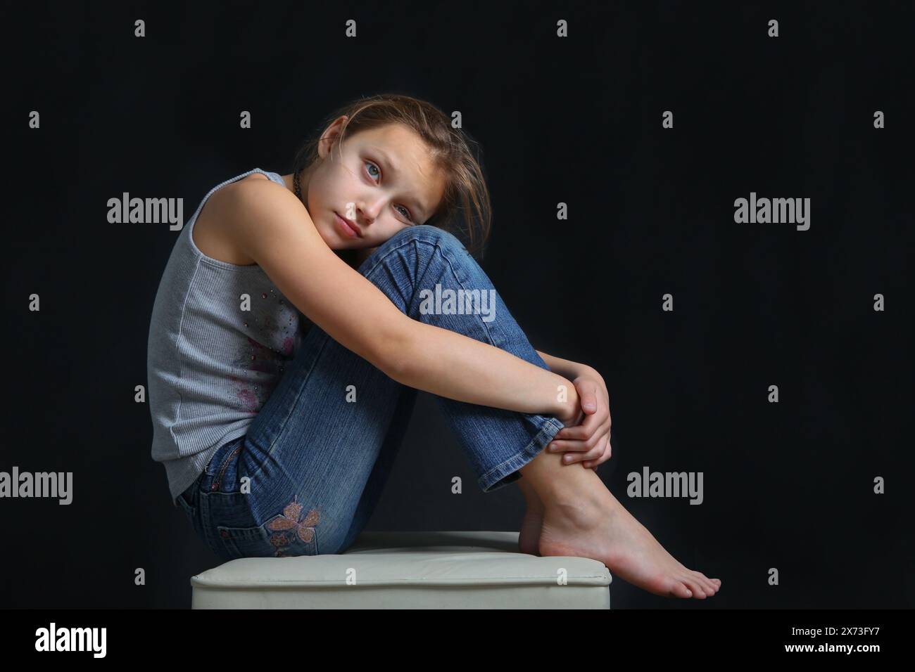 portrait of a sad preteen girl on black background Stock Photo - Alamy