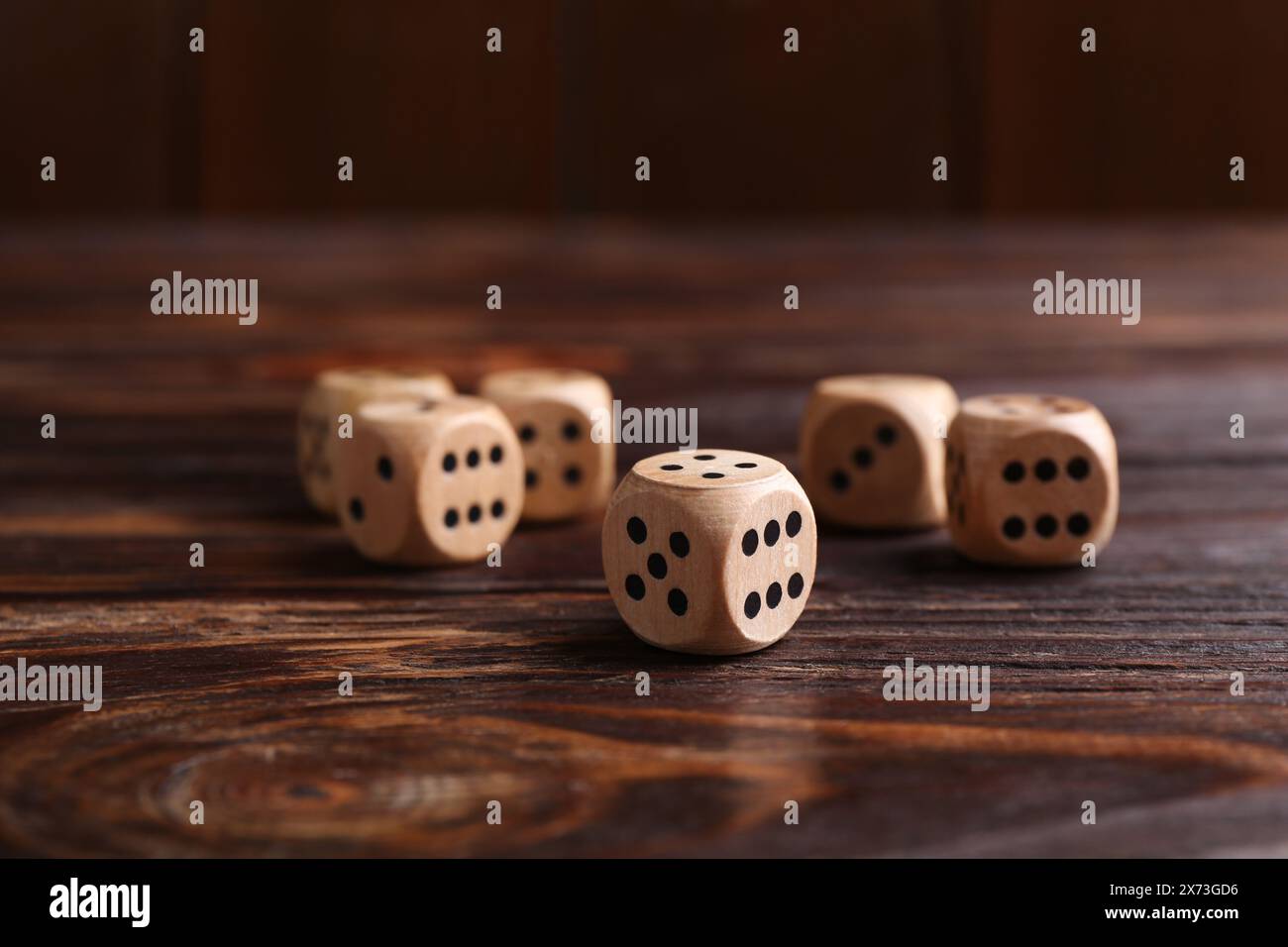 Many game dices on wooden table, closeup Stock Photo - Alamy