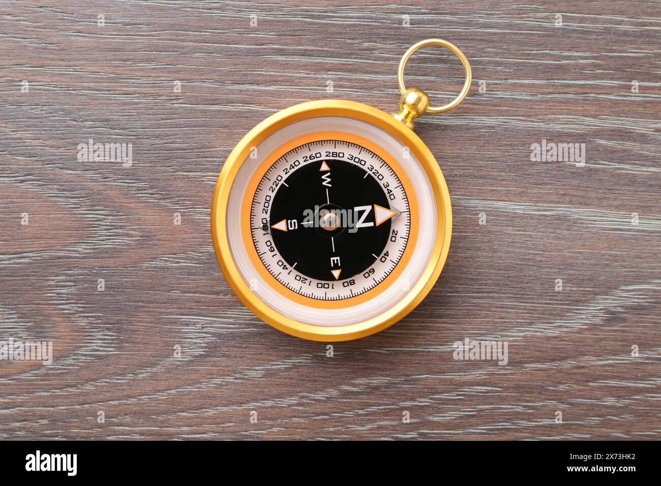 One compass on wooden table, top view Stock Photo - Alamy