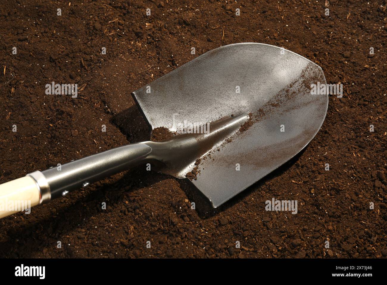 Metal shovel on fertile soil. Gardening tool Stock Photo - Alamy