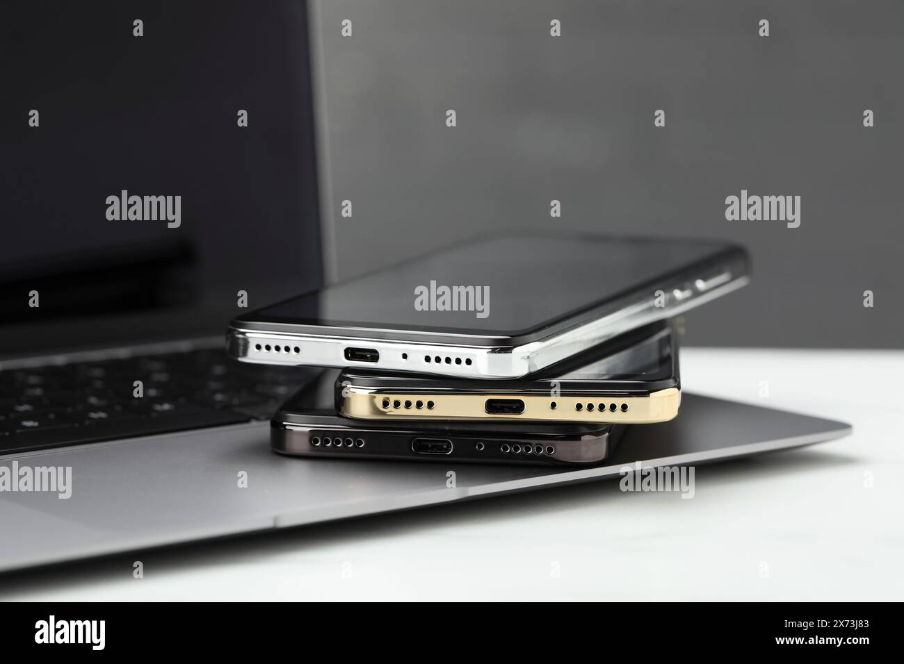 Stack of electronic devices on white table Stock Photo - Alamy