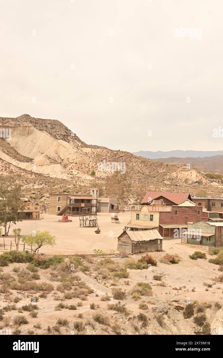 Western-style town set in a desert landscape with rugged hills in the ...