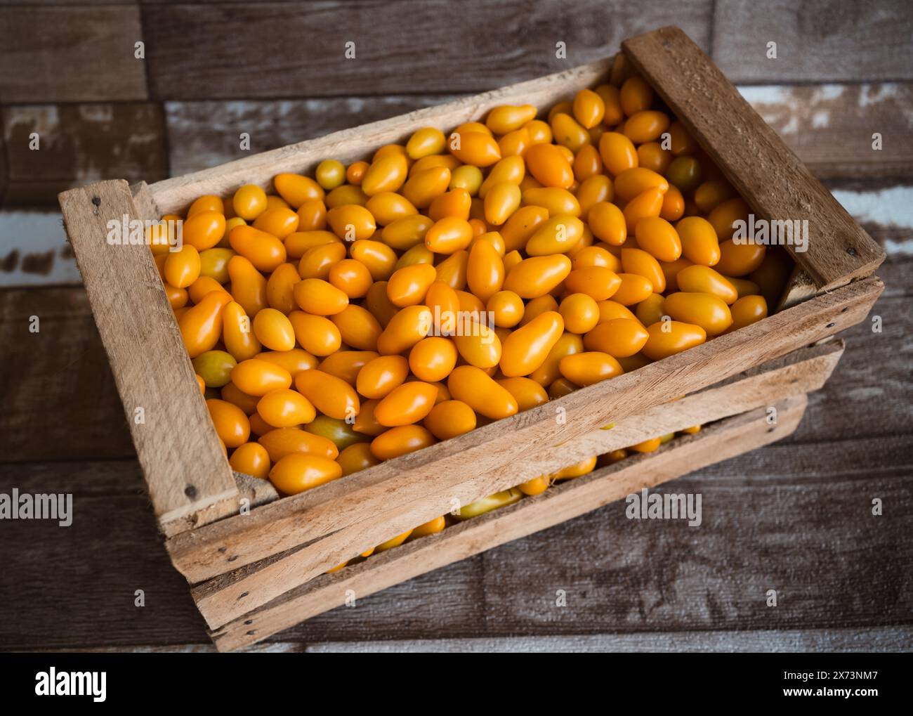 Fresh yellow cherry tomatoes in the wooden box Stock Photo - Alamy
