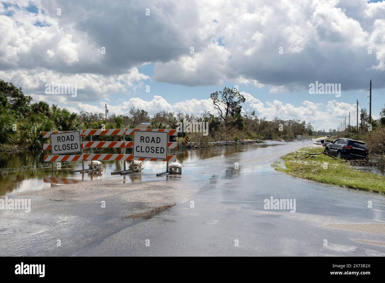 Road closed for roadworks and danger of flooding with warning signs ...