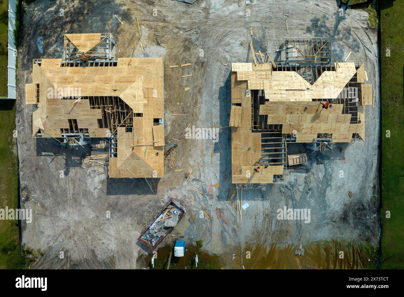 Professional builders working on roof construction of unfinished ...