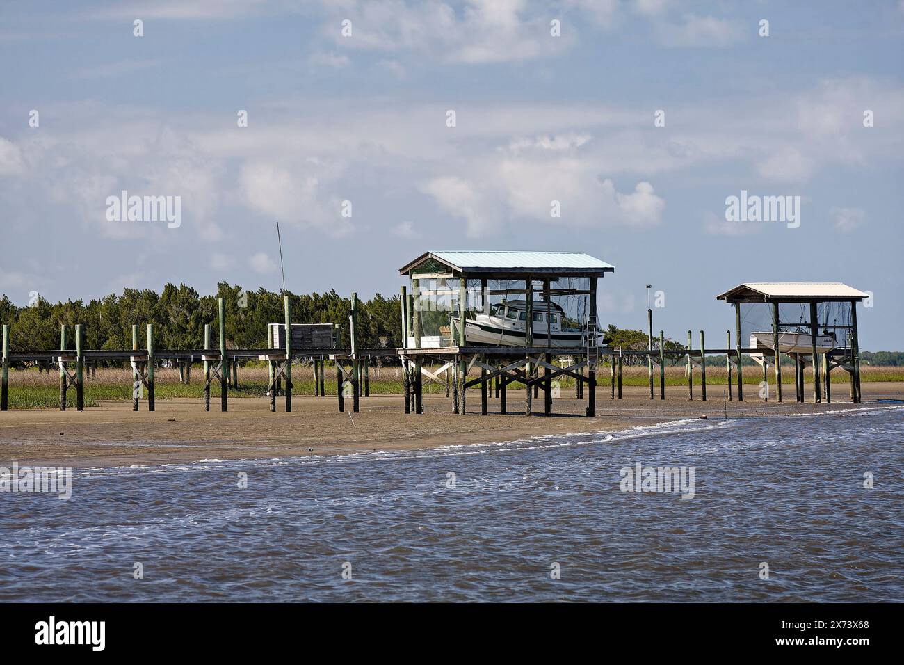 low tide; 2 high docks; covered, pilings; motor boats; lifts; netting ...