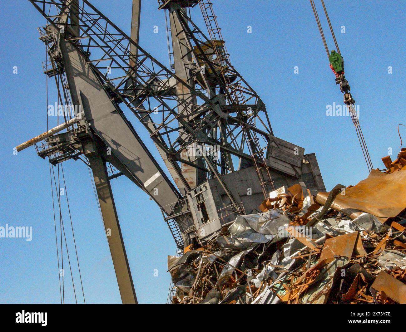 Dockside crane and scrap metal Stock Photo - Alamy