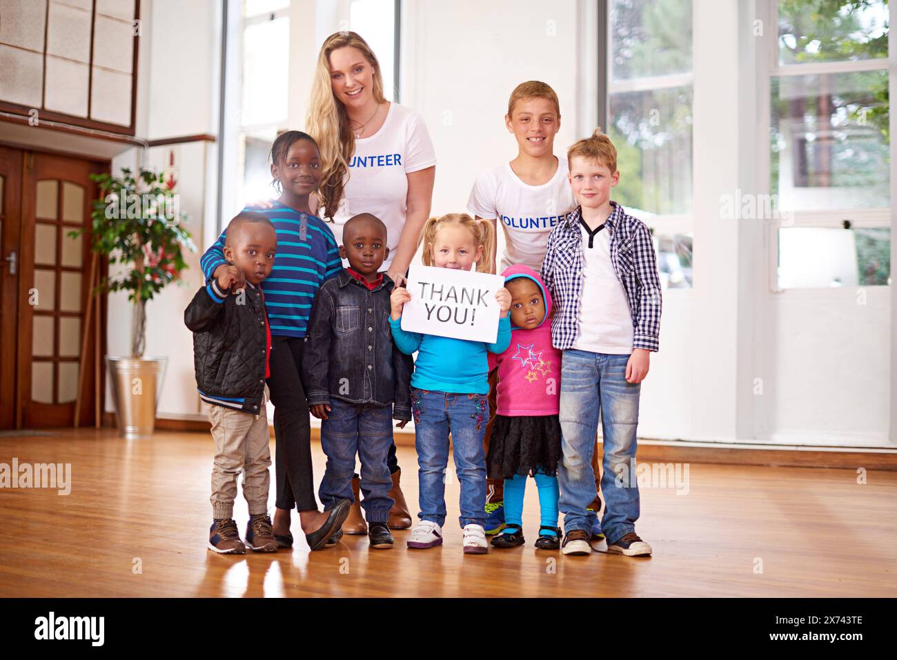 Children, volunteer and portrait at orphanage for donation, help and ...