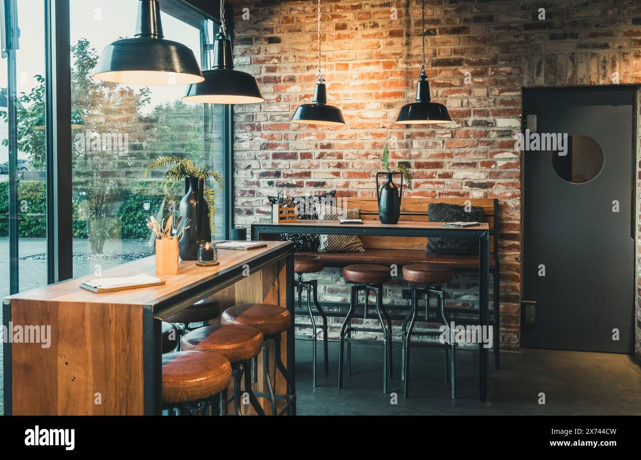 Seating area with bar tables and bar chairs in a modern cafe ...