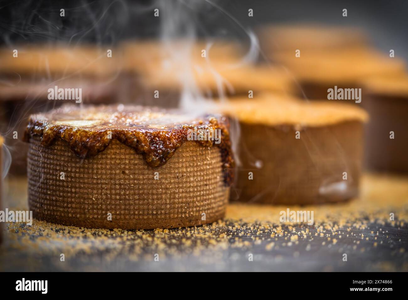 A tart is caramelized with a hot iron. Caramelization process Stock ...