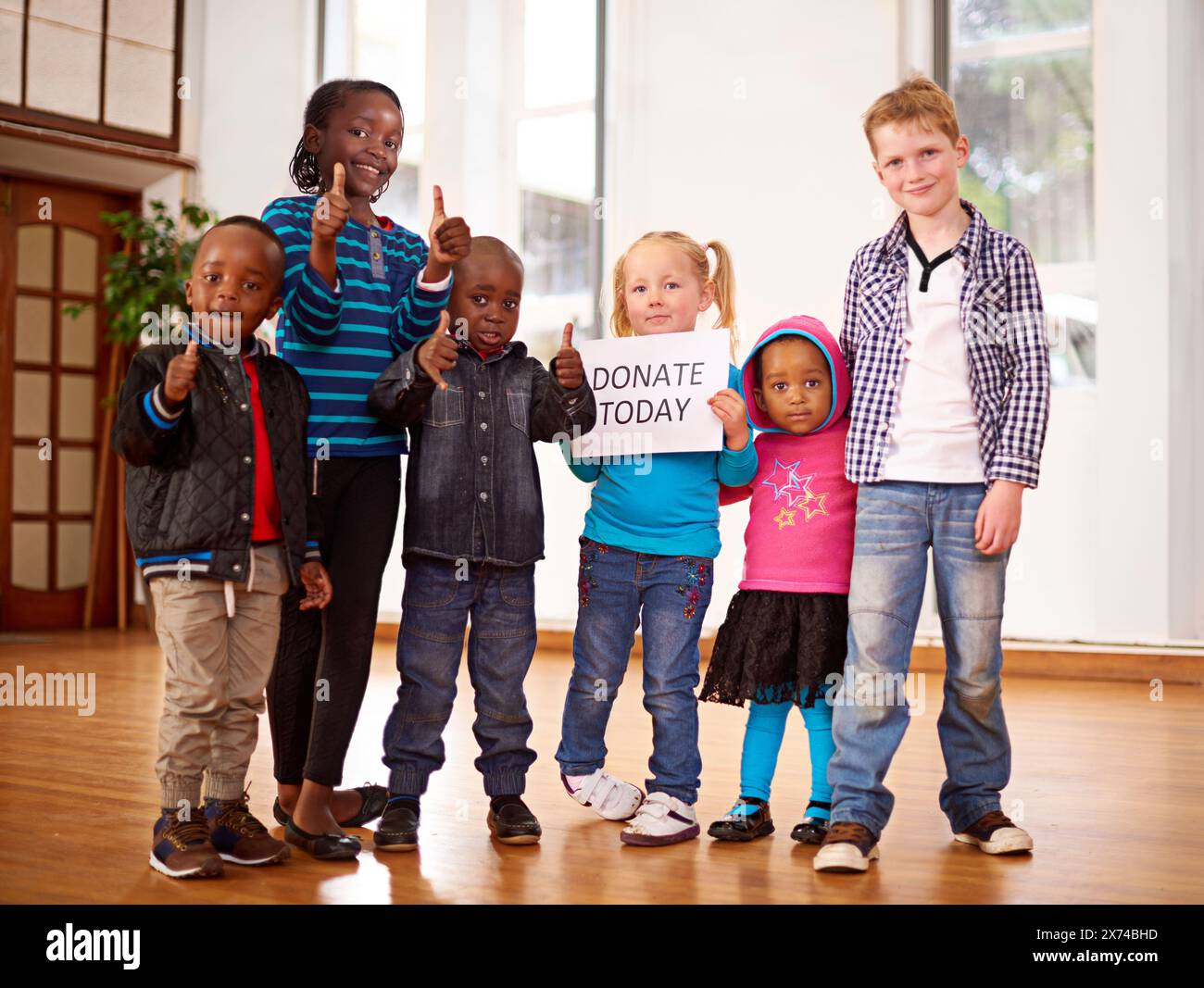 Kids, volunteer and thumbs up for donation, portrait and thank you for ...