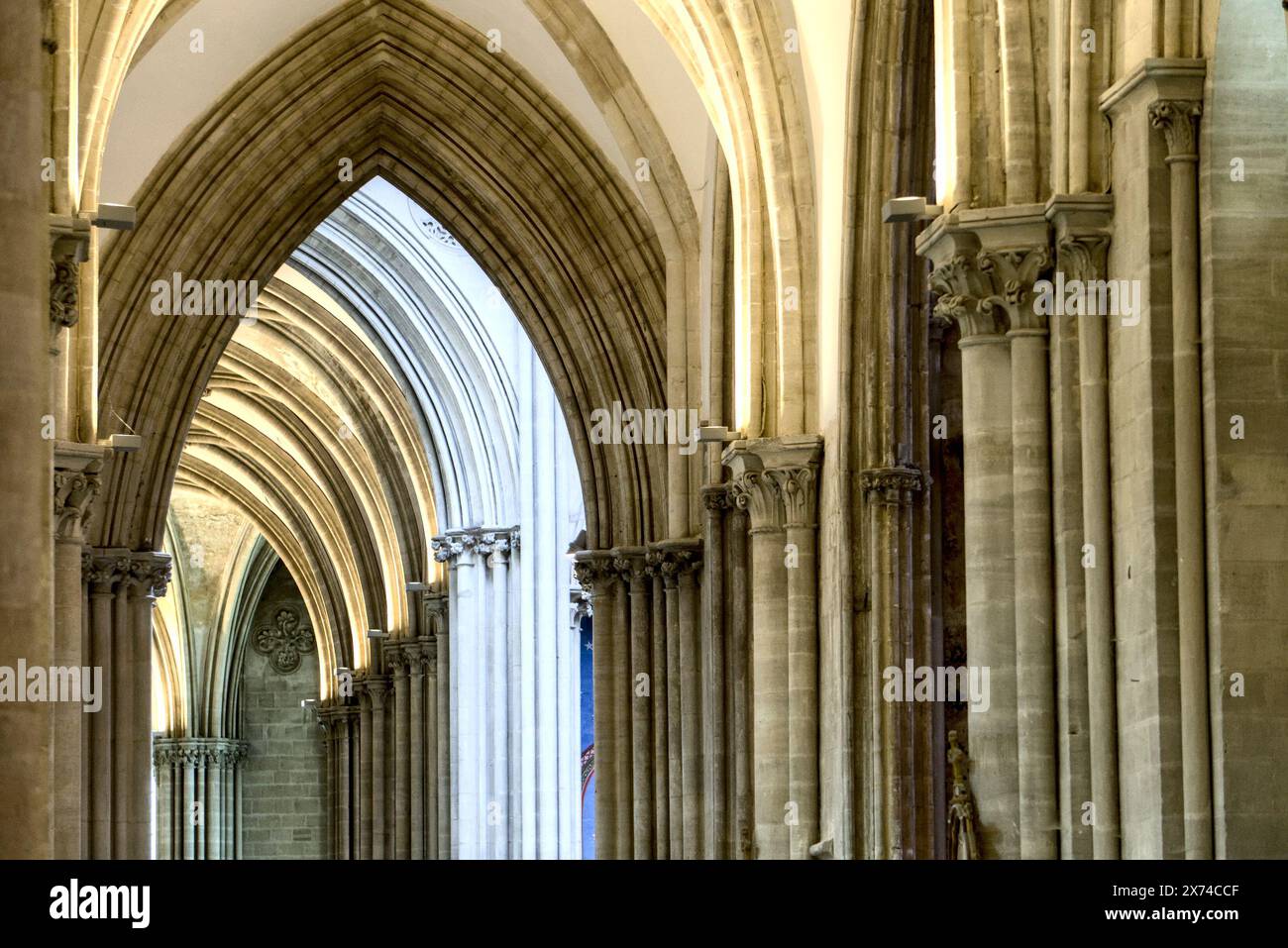 Bayeux cathédral, France. Tall stone arches with daylight in the middle ...